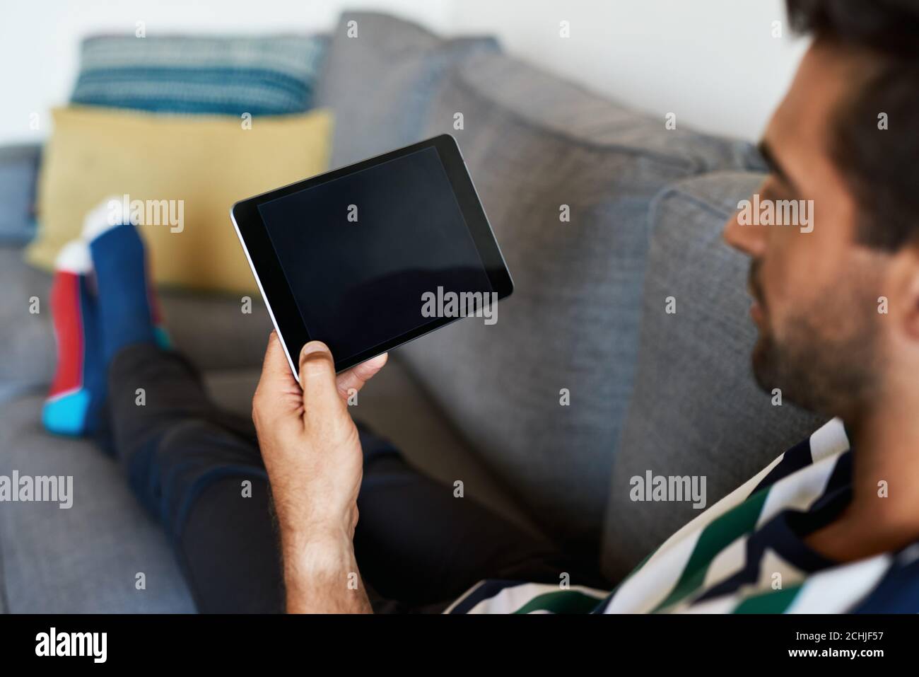 Sofa tablet man hi-res stock photography and images - Alamy