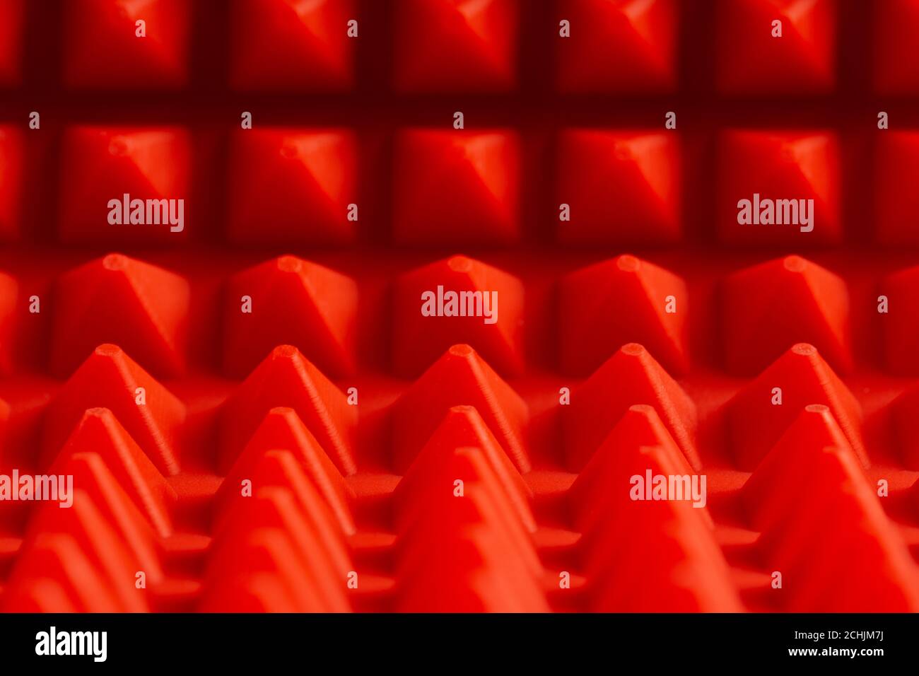 abstract red silicone pyramids mat close-up background Stock Photo - Alamy