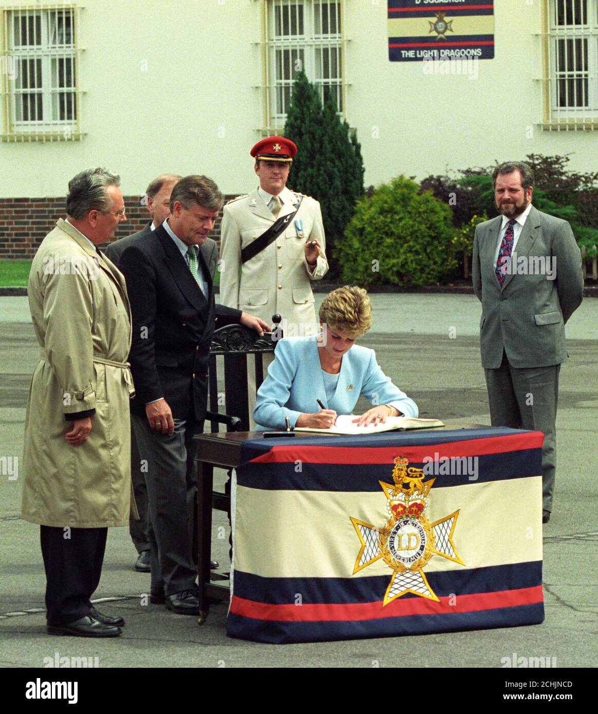 The Princess of Wales signs the visitor's book when she visited the ...
