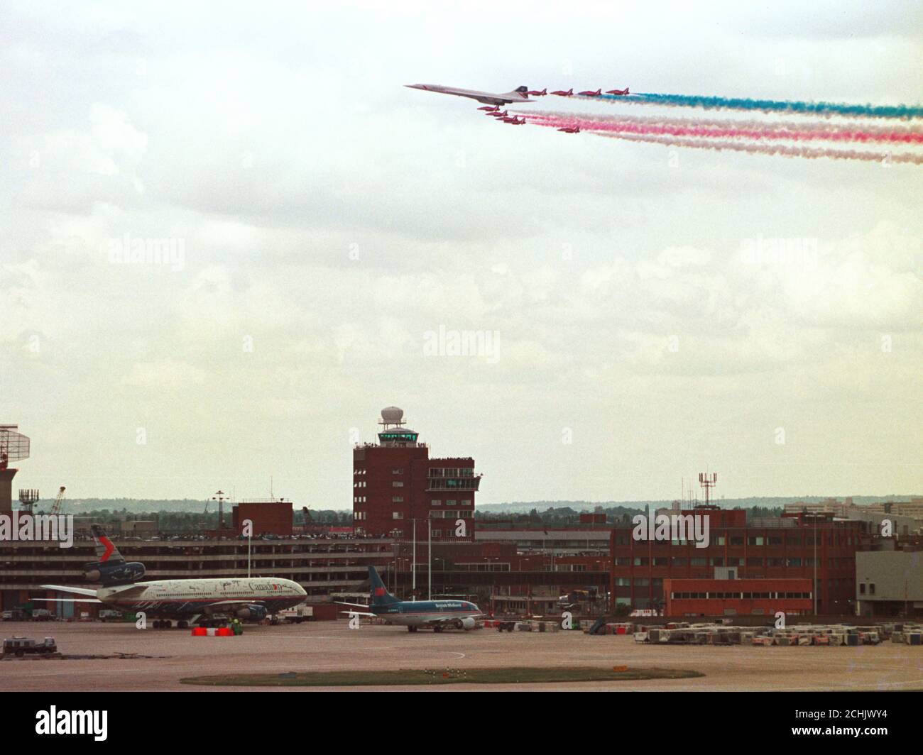 A British Airways Concorde leads the Royal Air Force's Red Arrows ...