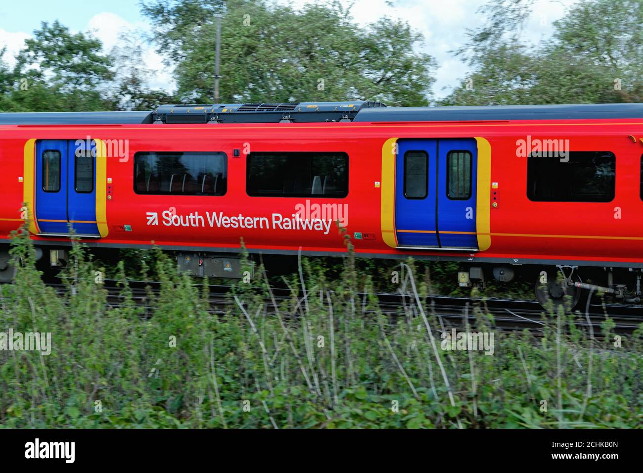 A South Western Railway train on route through countryside in Surrey ...
