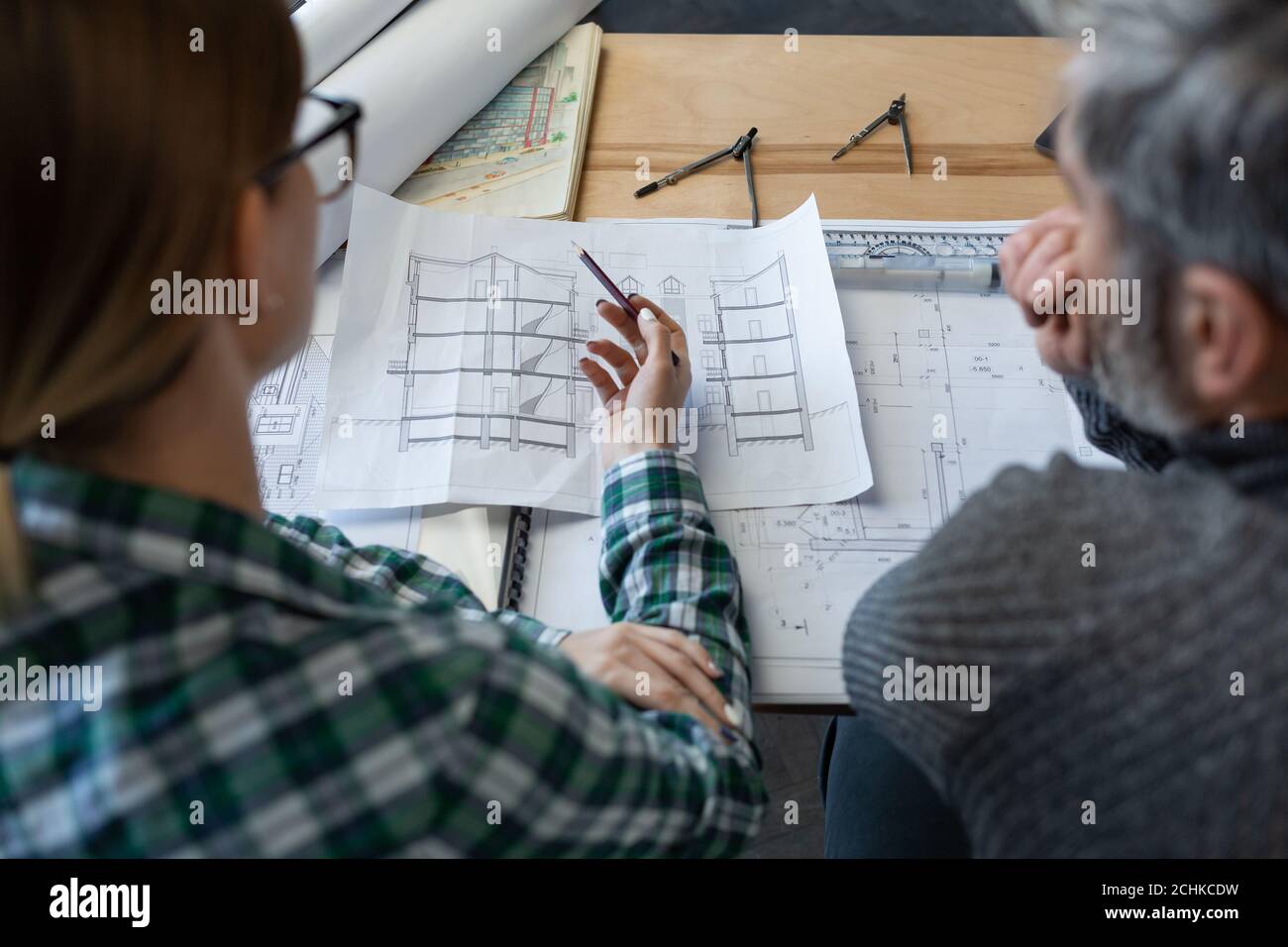Interior designers team working in office with blueprints and architect ...