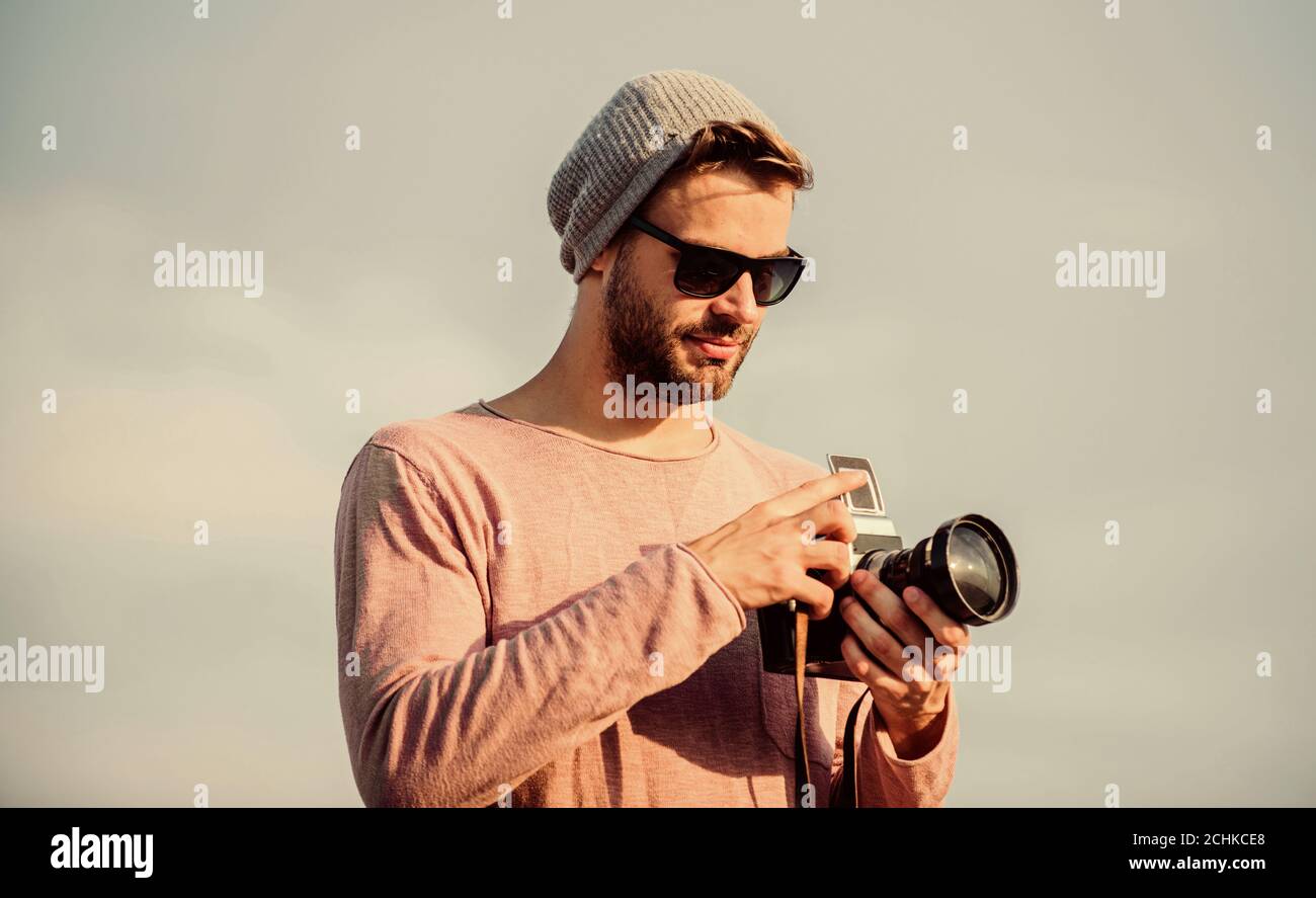 Manual settings. Guy photographer outdoors sky background. Hipster ...