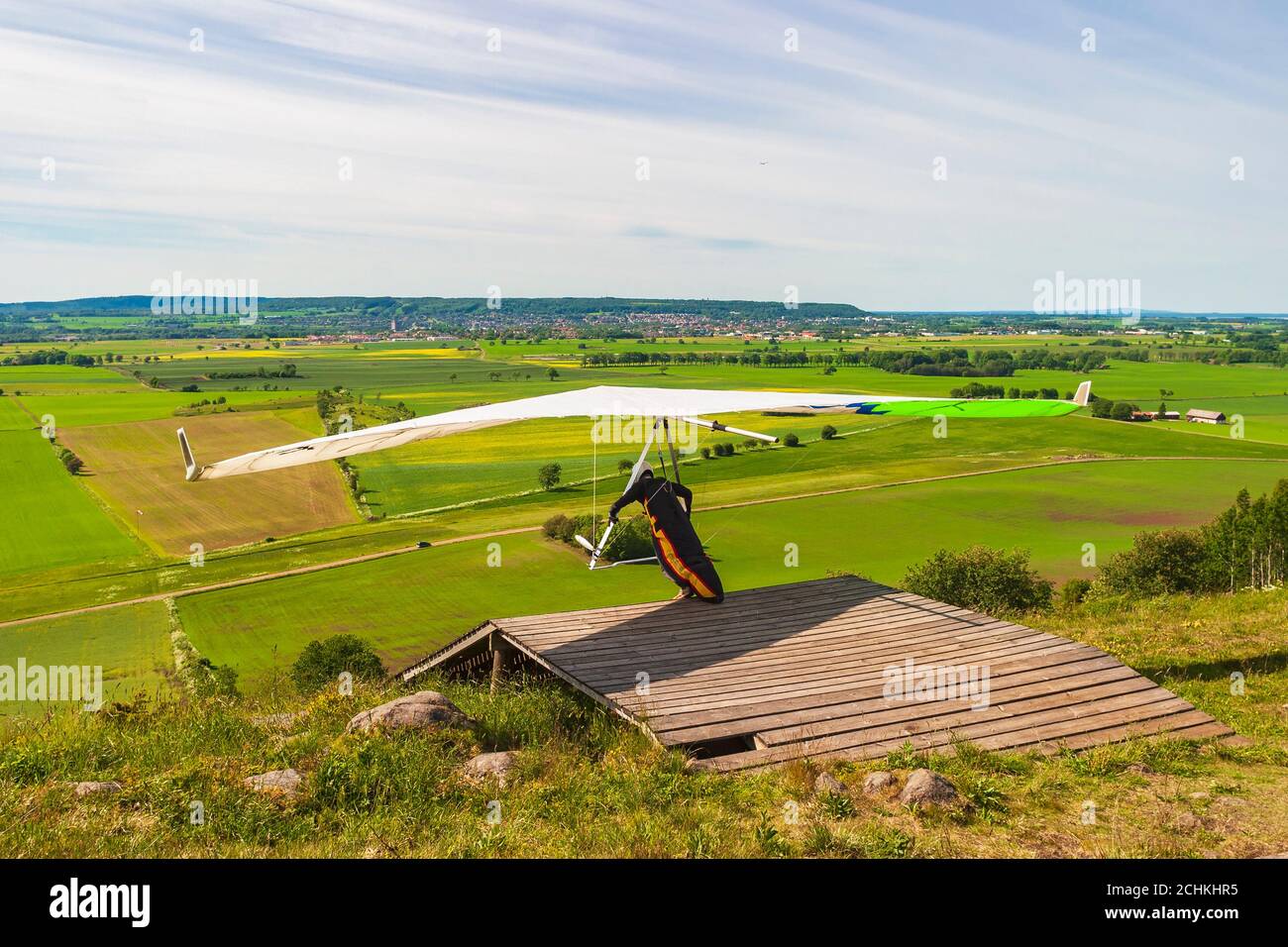 Hang glider start at a ramp on a hill in a beautiful country landscape ...