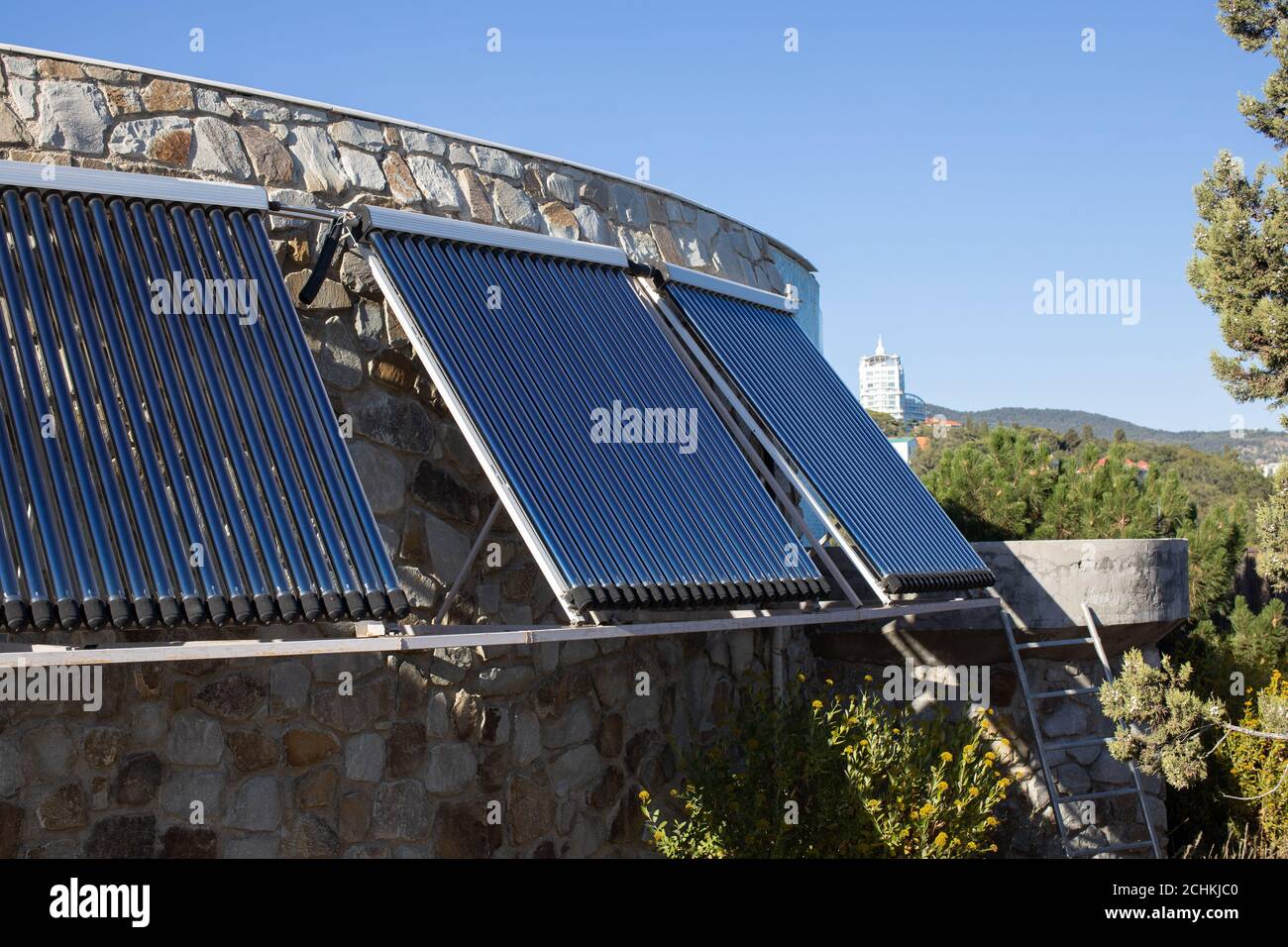 Solar water heating system installed on wall or roof of house. 3 panels ...