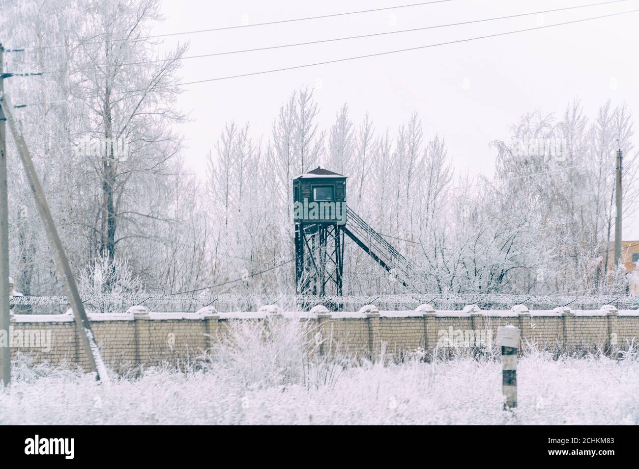 Prison tower at the fence with barbed wire. in winter in snow Stock ...