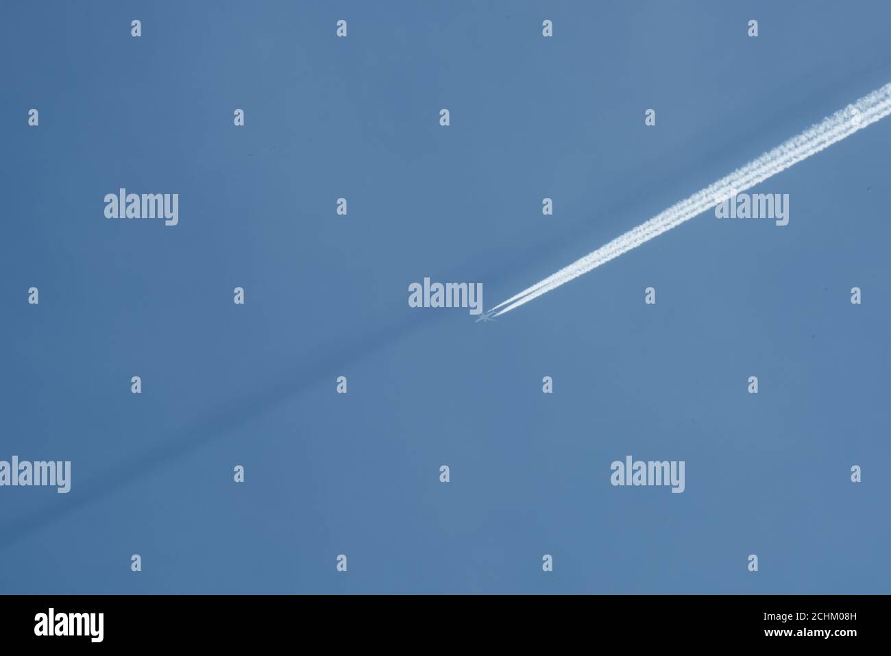 Aircraft With Vapour Trail. The Vapour Trail Has Shadow As The Plane Is ...