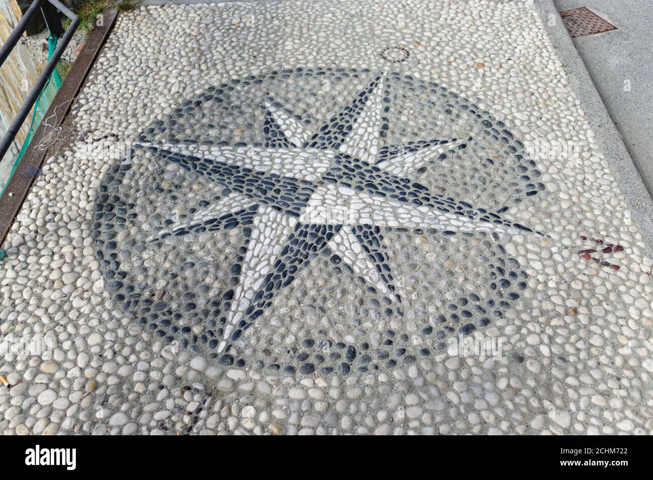 Compass paved ground with pebbles Stock Photo - Alamy