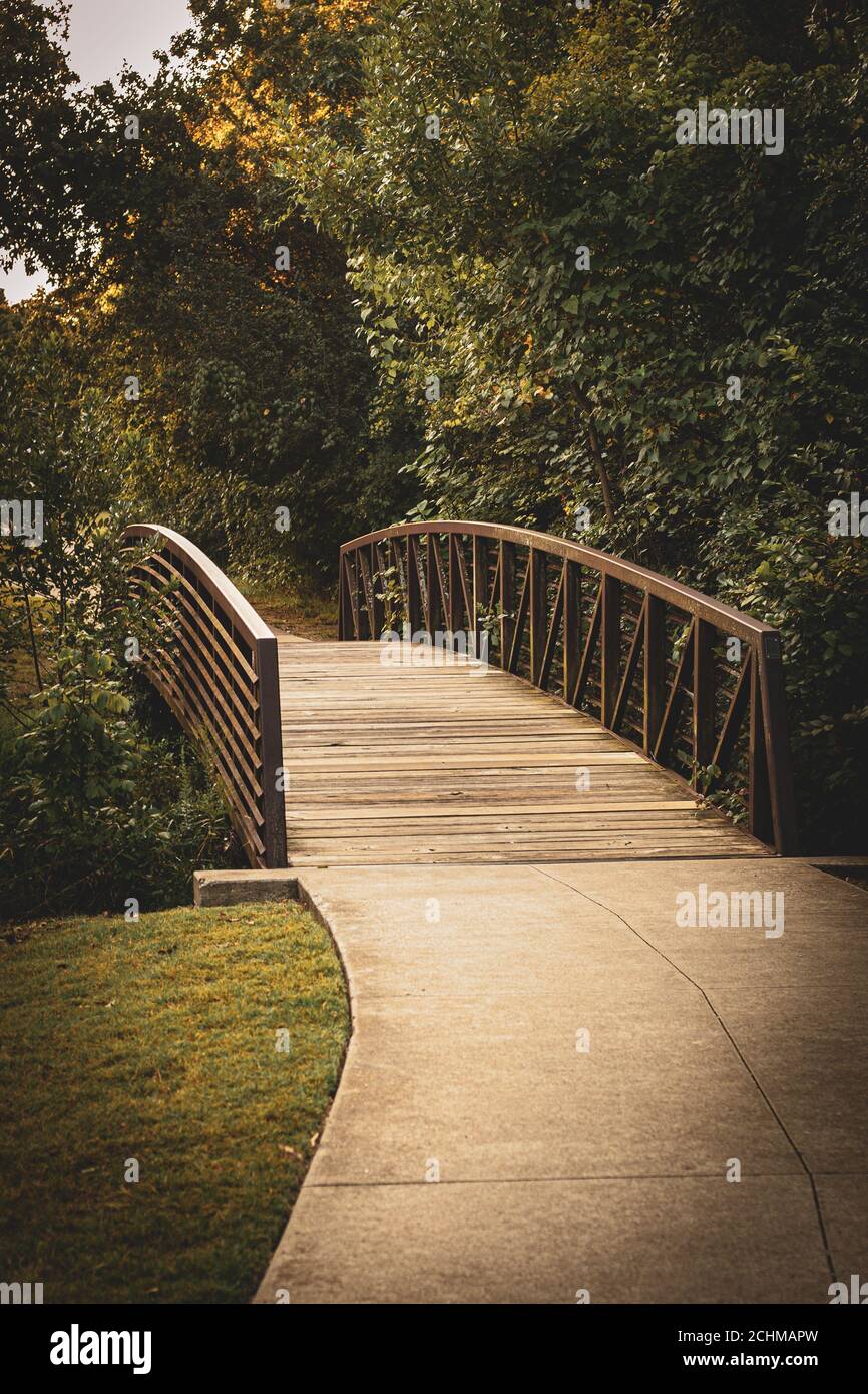 Rustic iron bridge walking path on fall day Stock Photo - Alamy