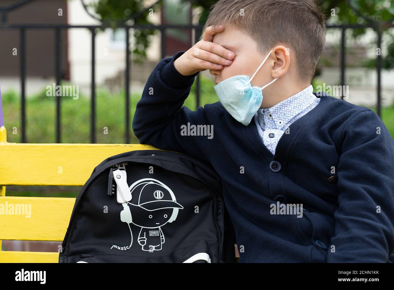 tired kid boy wearing a face mask for coronavirus prevention. Back to ...