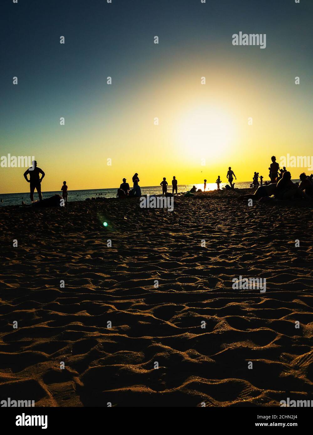 crowd at the sunset beach Stock Photo - Alamy