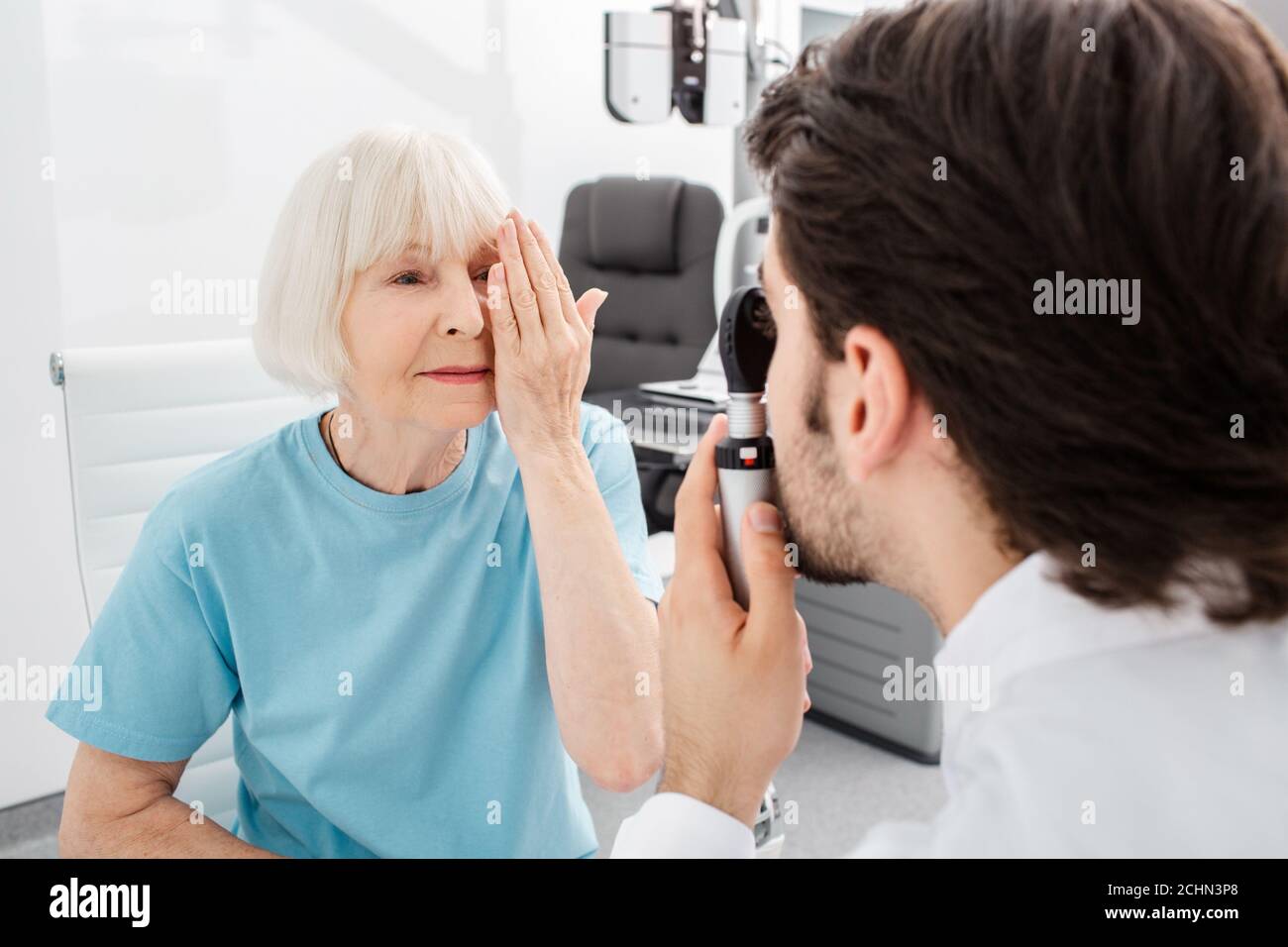 Senior woman patient checking vision in optician's office. Eye exam and vision diagnostic Stock ...