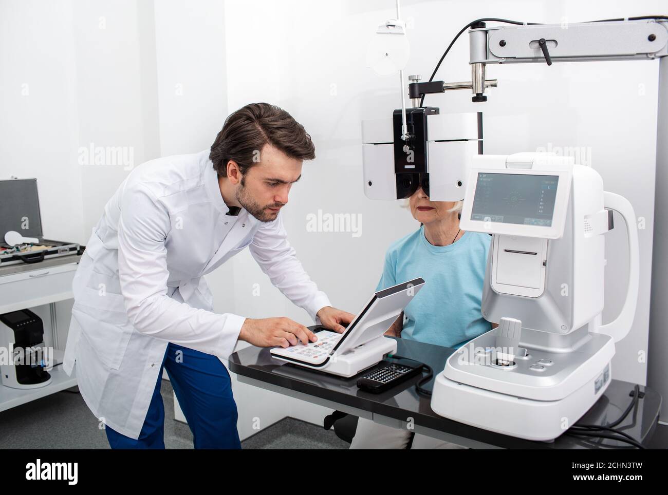 Experienced optometrist doing site testing for a patient using a modern ...