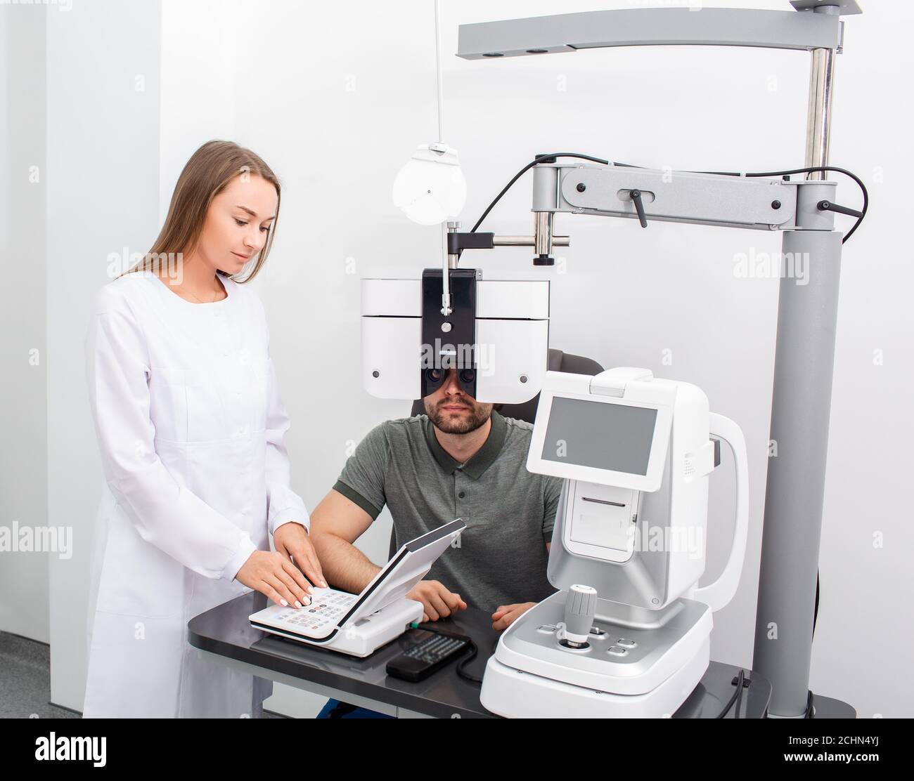 Woman ophthalmologist doing sight testing for a patient using a modern ...
