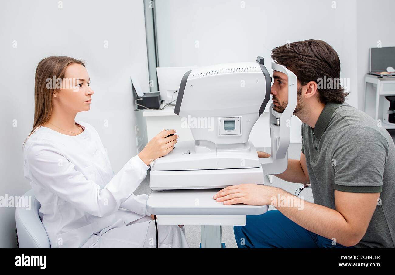 Experienced ophthalmologist using autorefractor calculate the vision ...