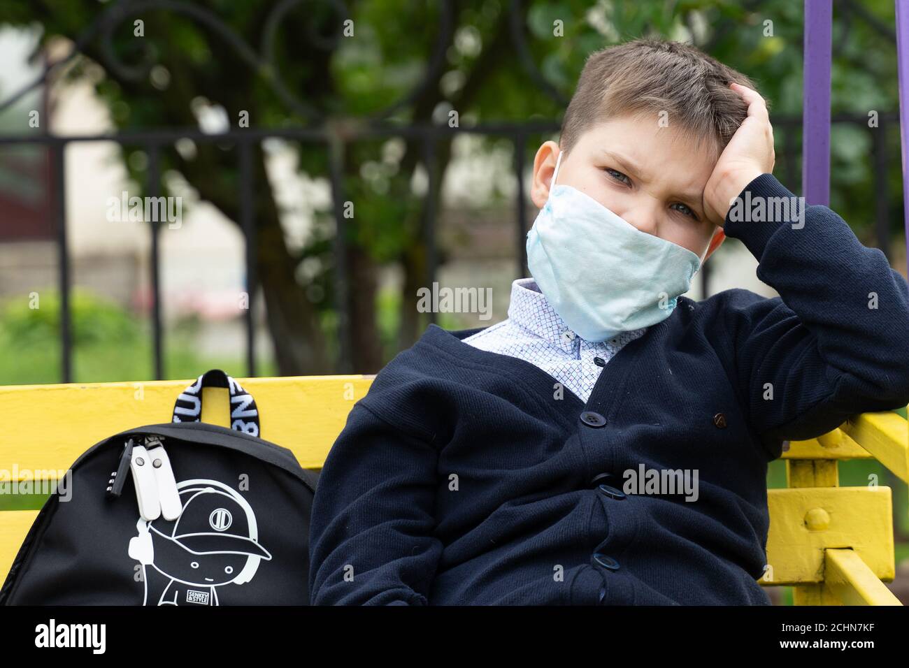 school child boy wearing medical face mask. preteen with school bag ...