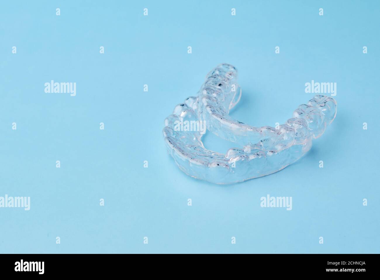 Close up invisible aligners on the blue background with copy space ...