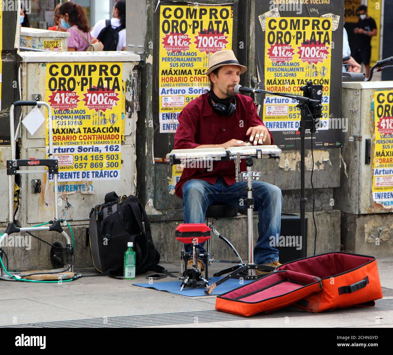 Busker playing a flat stringed musical instrument seated in the Gran ...