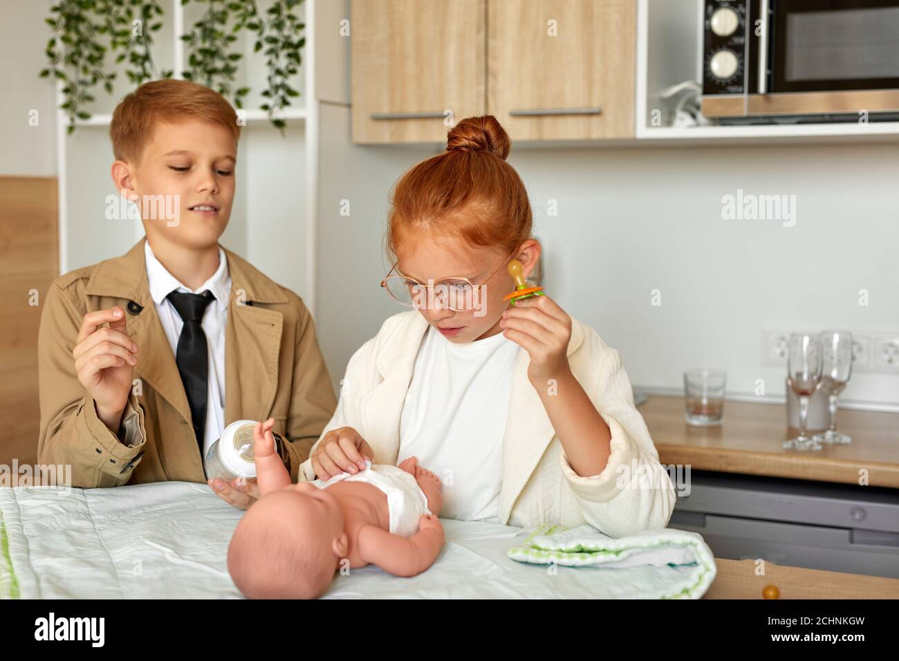young caucasian family parents kids changing diapers to their newborn ...