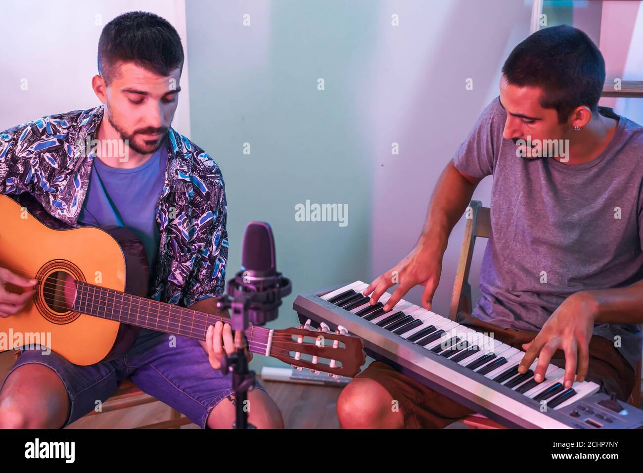 Young musicians working at home with his video camera making online ...