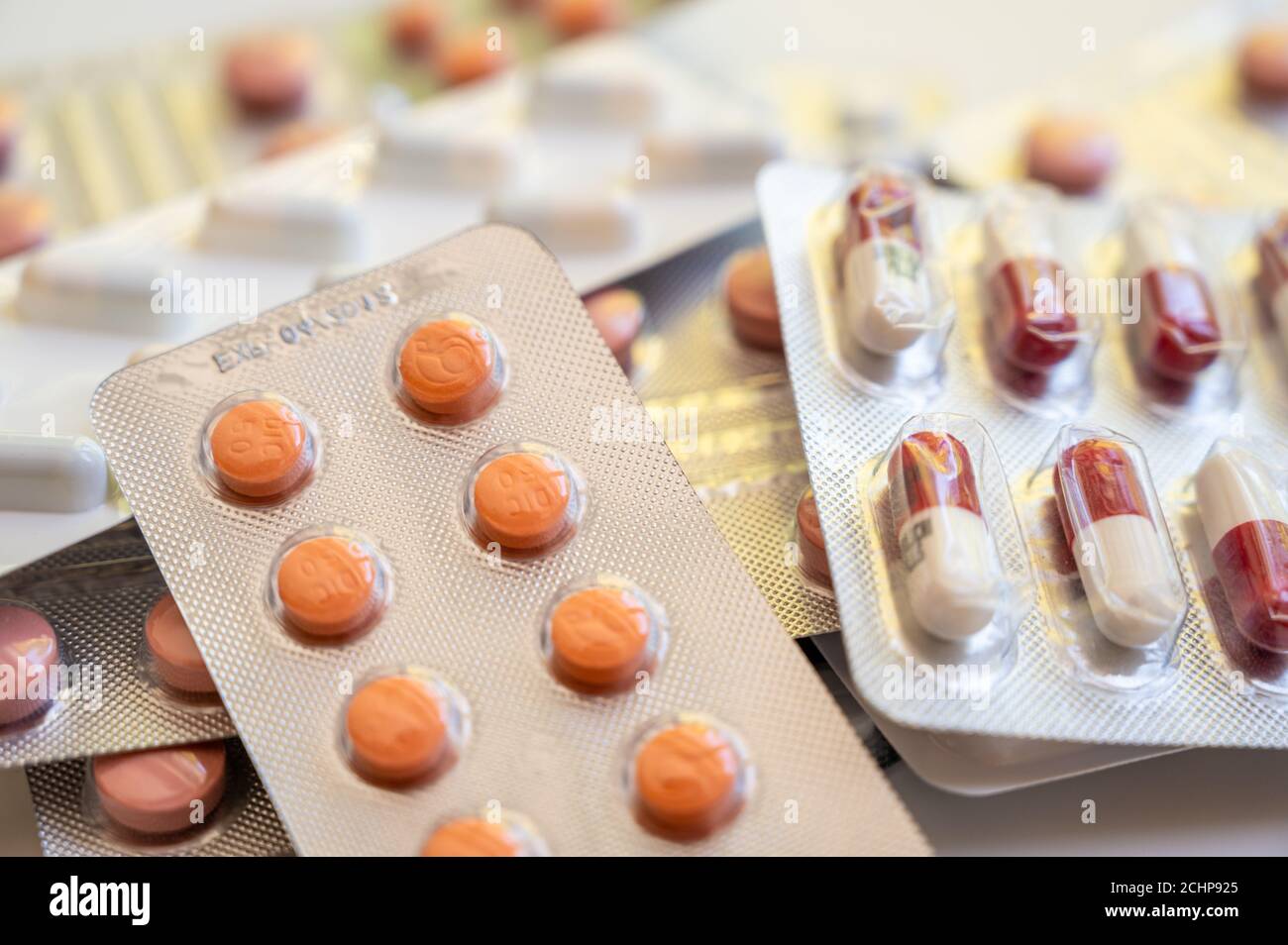 Closeup of a pile of blister packs with various medicine tablets and ...