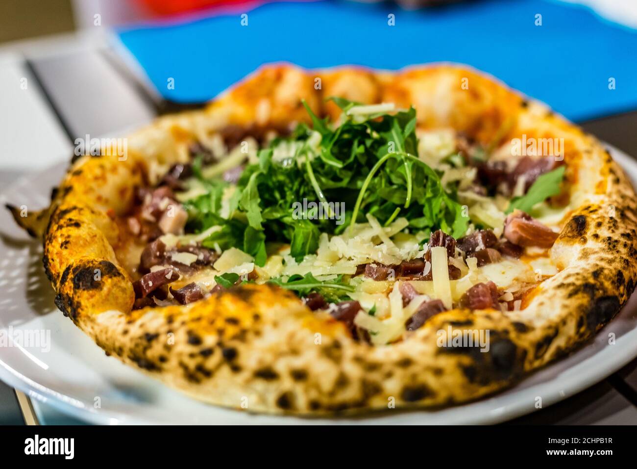 closeup of pizza with rocket, parmesan and ham Stock Photo - Alamy
