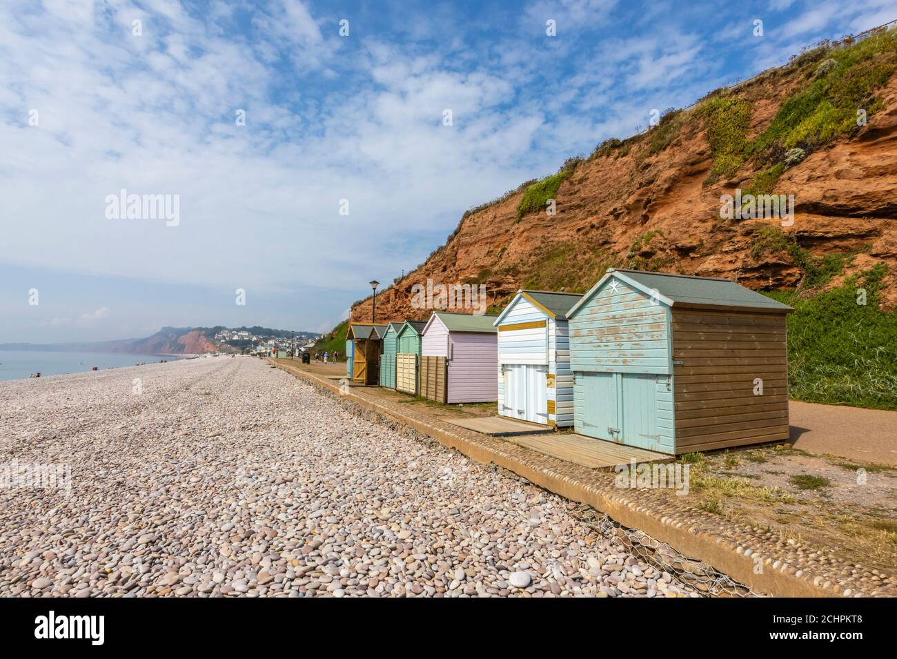 Typical seafront beach huts on the promenade at Budleigh Salterton, a ...