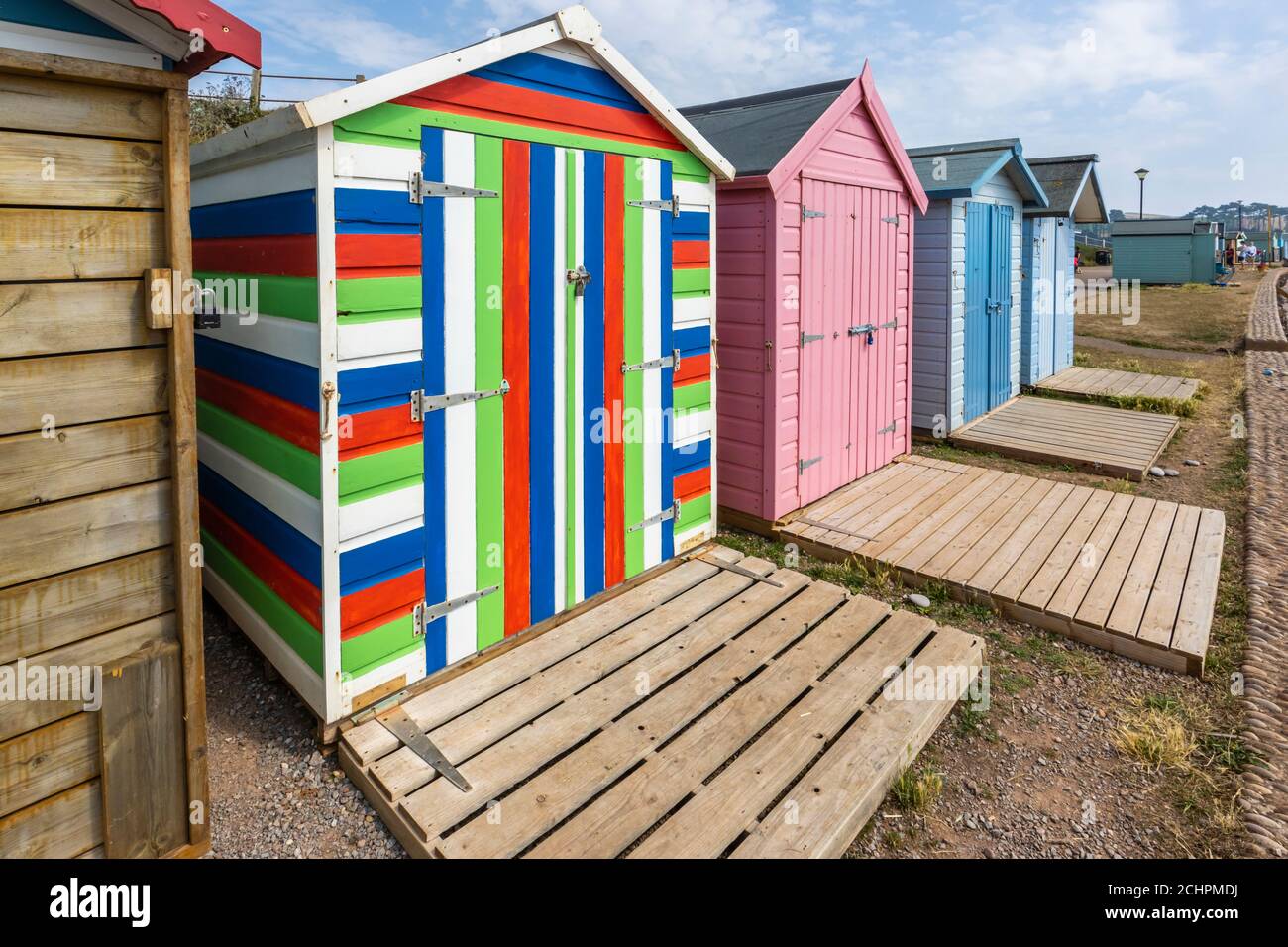 Typical seafront beach huts on the promenade at Budleigh Salterton, a ...