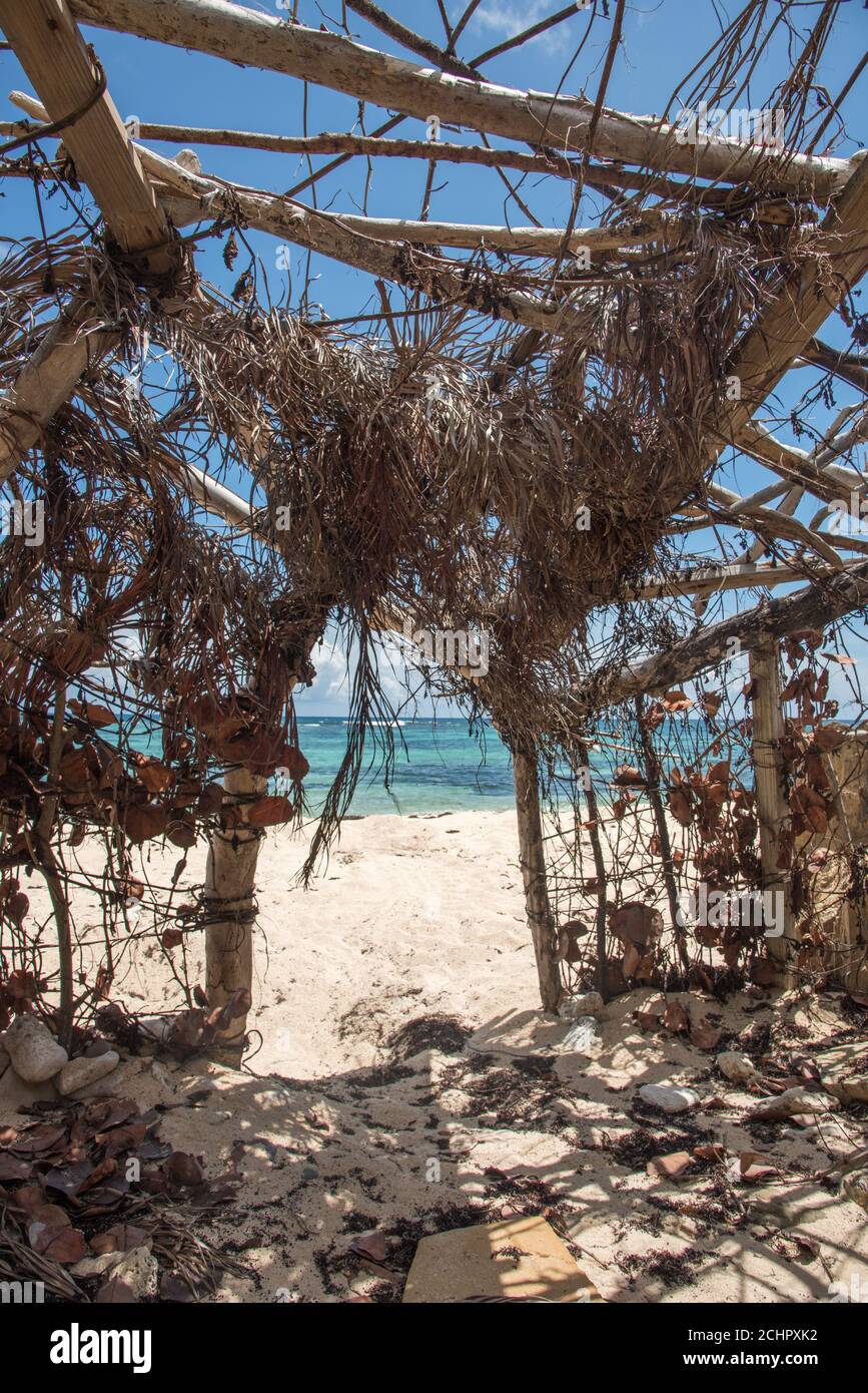 Manmade beach shelter with branches woven together at Isaac Bay beach ...