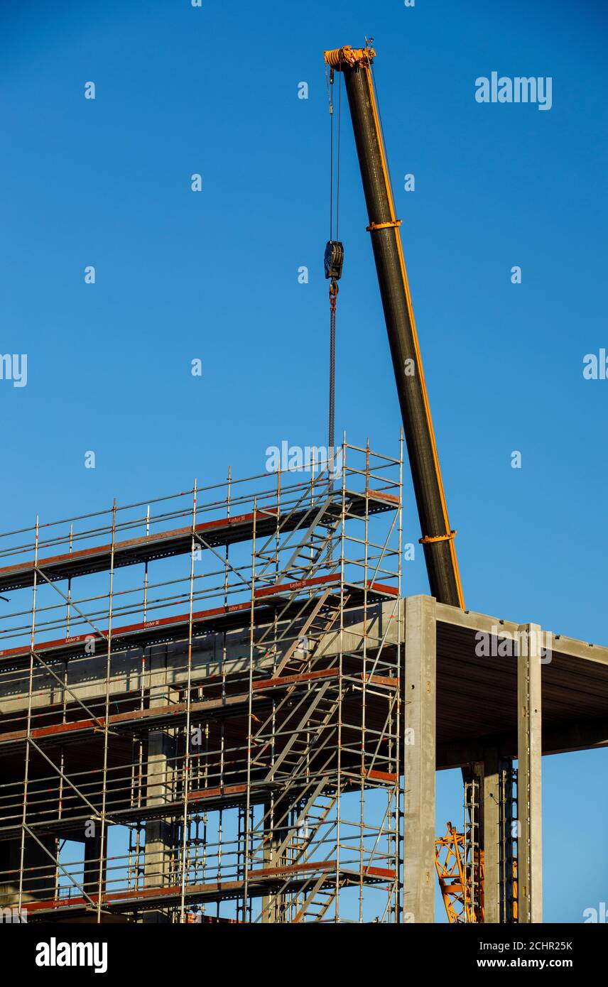 View of an empty construction site with metal scaffolding and crane ...