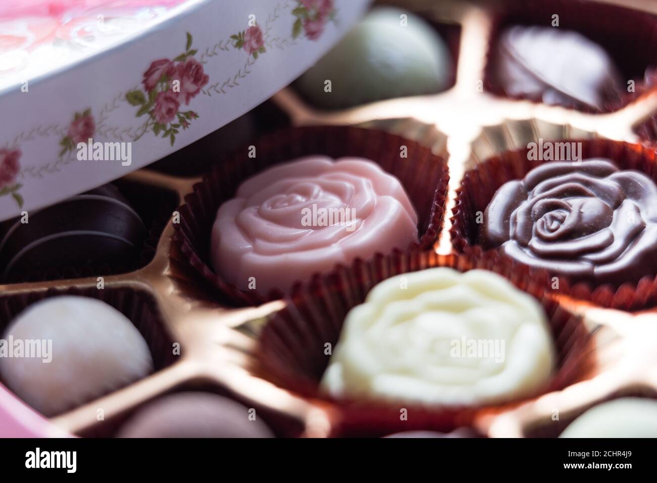 Assorted chocolates in pink box, shallow depth of field Stock Photo - Alamy