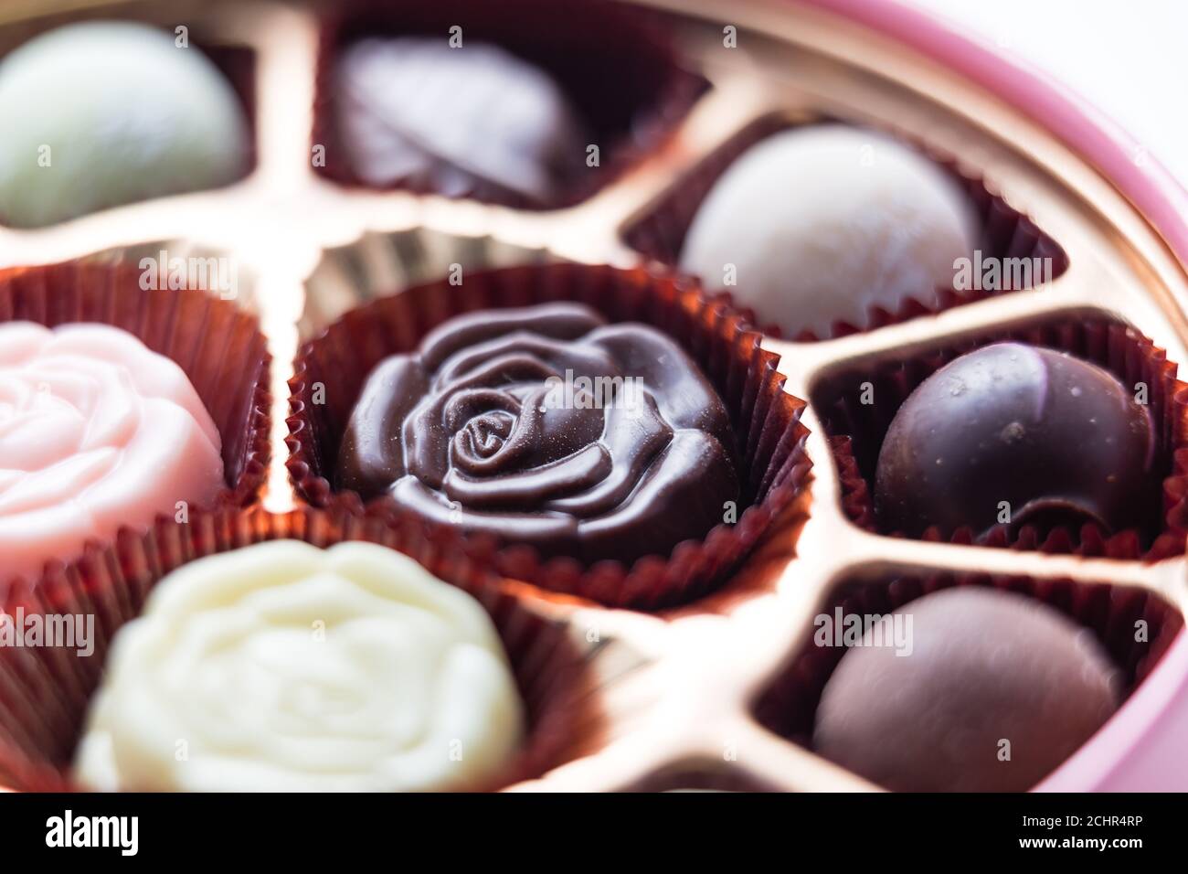 Assorted chocolates in pink box, shallow depth of field Stock Photo - Alamy