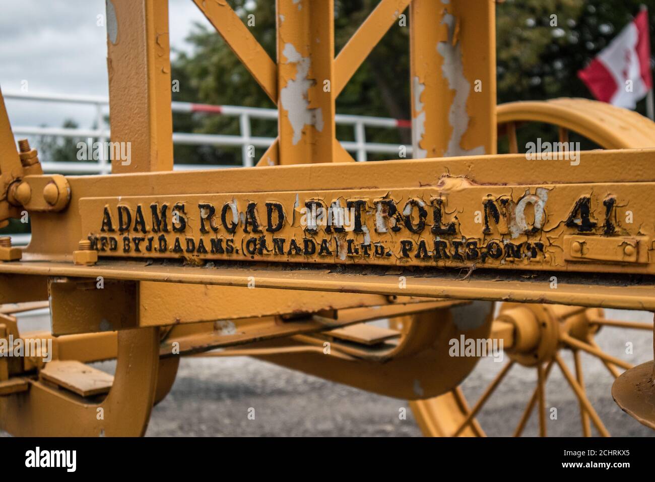 Detail of the logo and writing on a yellow Adams Road Patrol Grader No ...