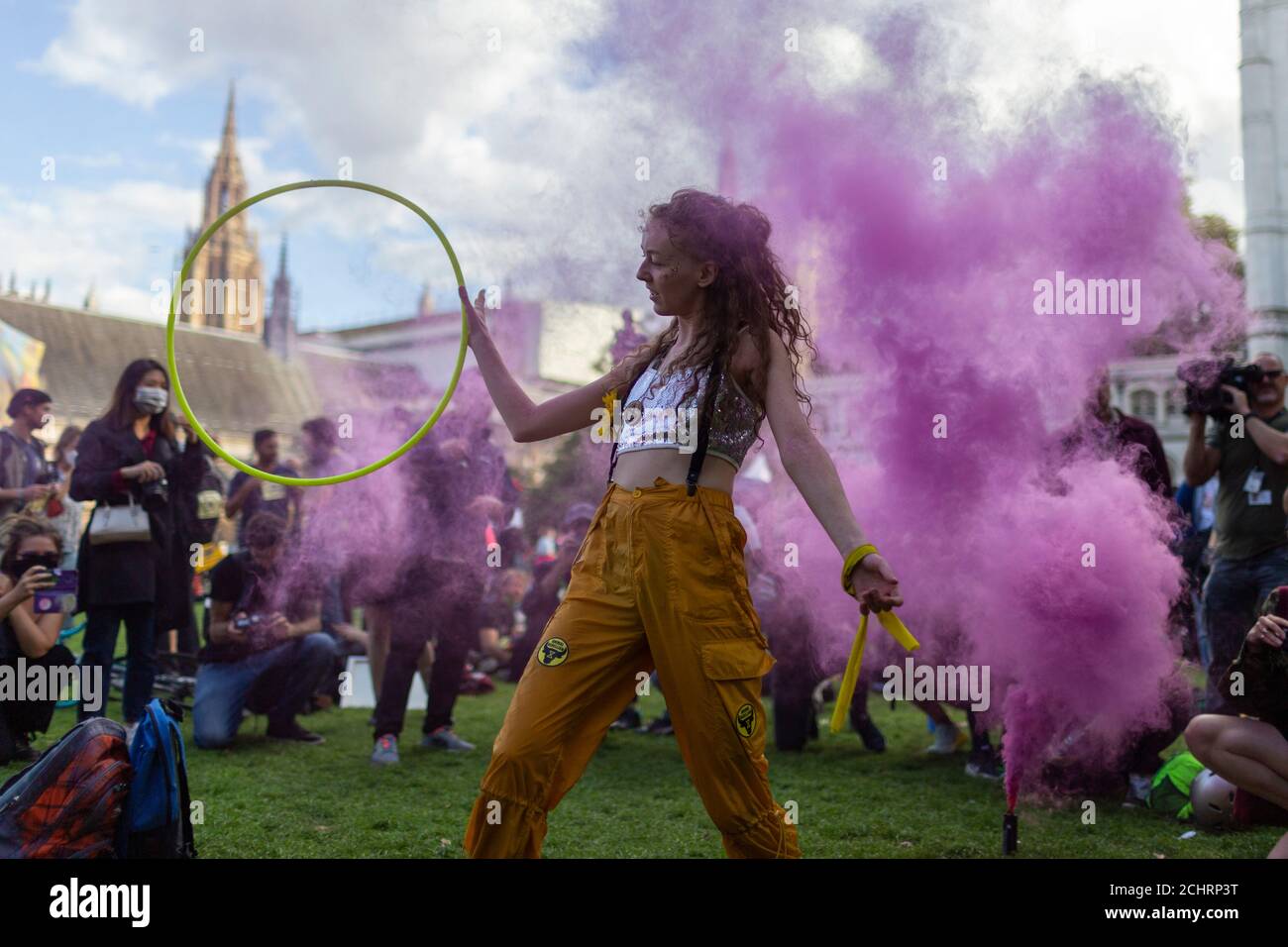 Hula hoop dancer and coloured smoke, Extinction Rebellion demonstration ...