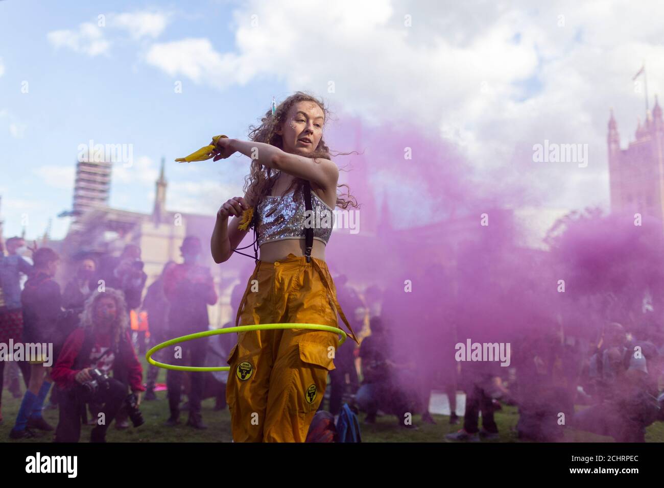 Hula hoop dancer and coloured smoke, Extinction Rebellion demonstration ...