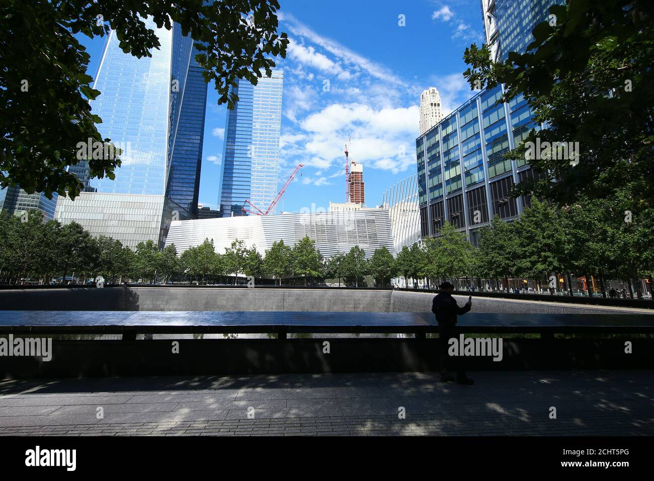 Visitors gather to pay tribute to the victims of 9/11 attacks near one ...