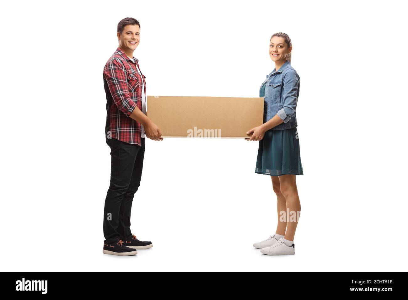 Young couple carrying a cardboard box together isolated on white ...