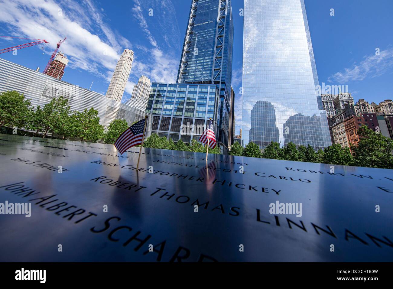 A US flag is is placed in one of the names inscribed in the bronze ...