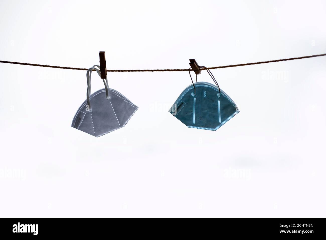 Face mask are hanging from rope on isolated white background Stock ...