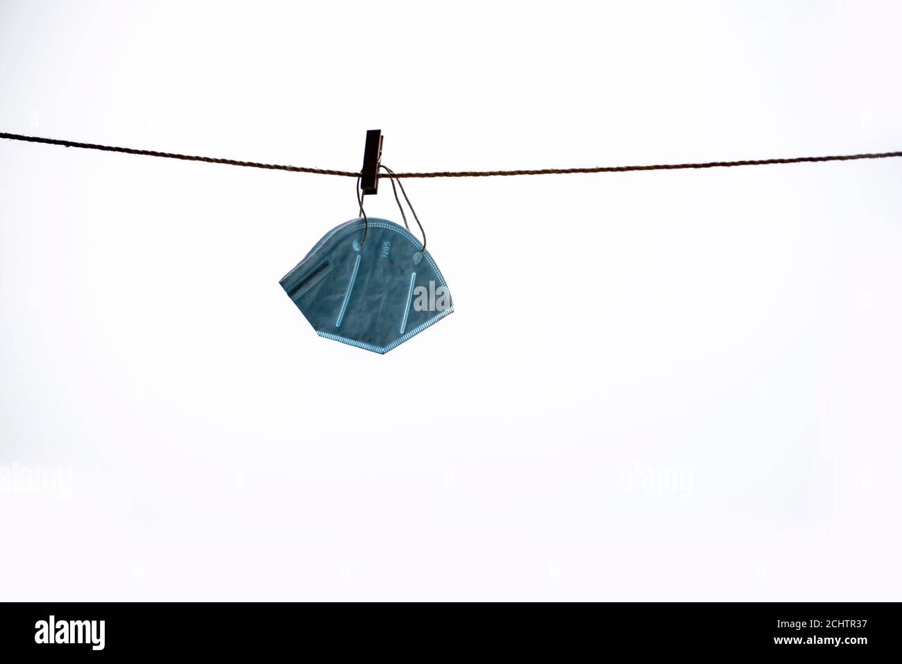 Face mask are hanging from rope on isolated white background Stock ...
