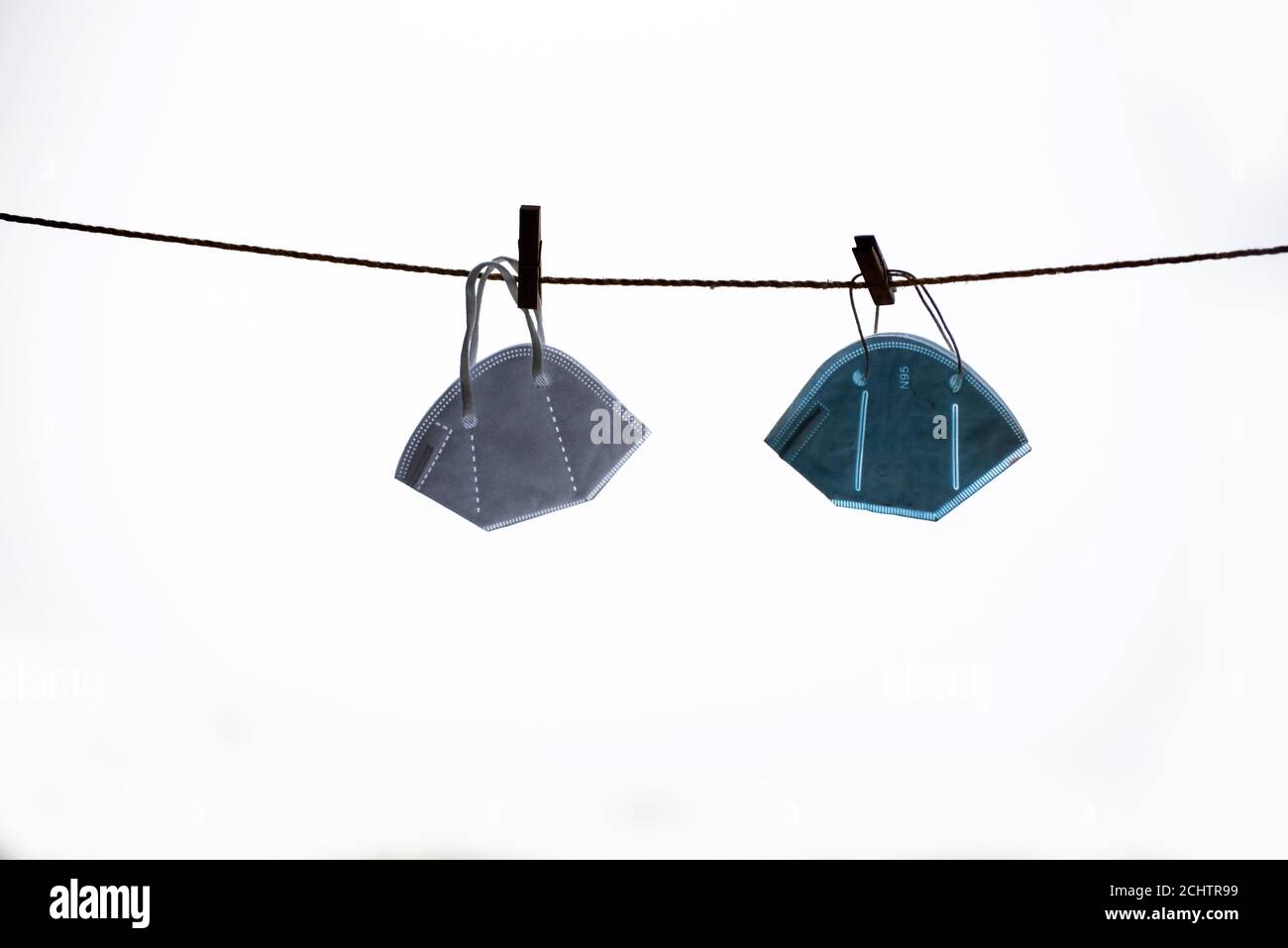 Face mask are hanging from rope on isolated white background Stock ...