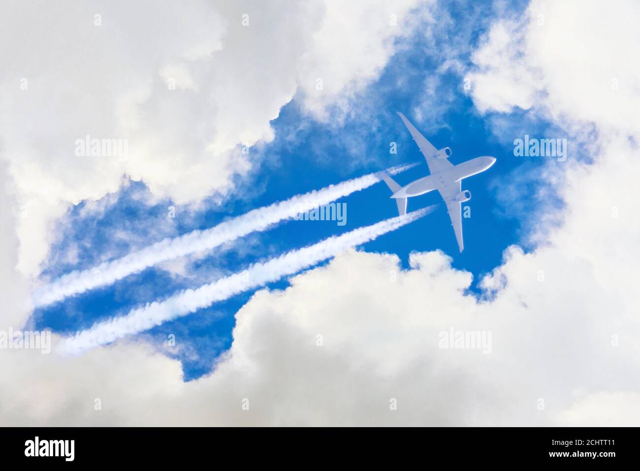 Airplane flies high in the sky, a journey through the clouds Stock ...