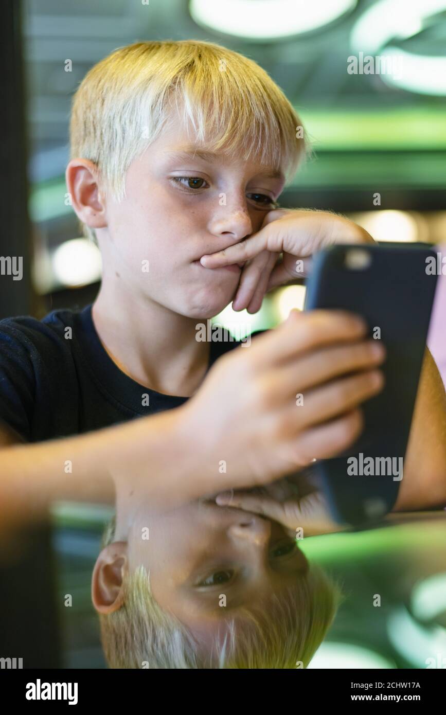 Bored kid with smartphone, child addicted to smartphone concept Stock ...