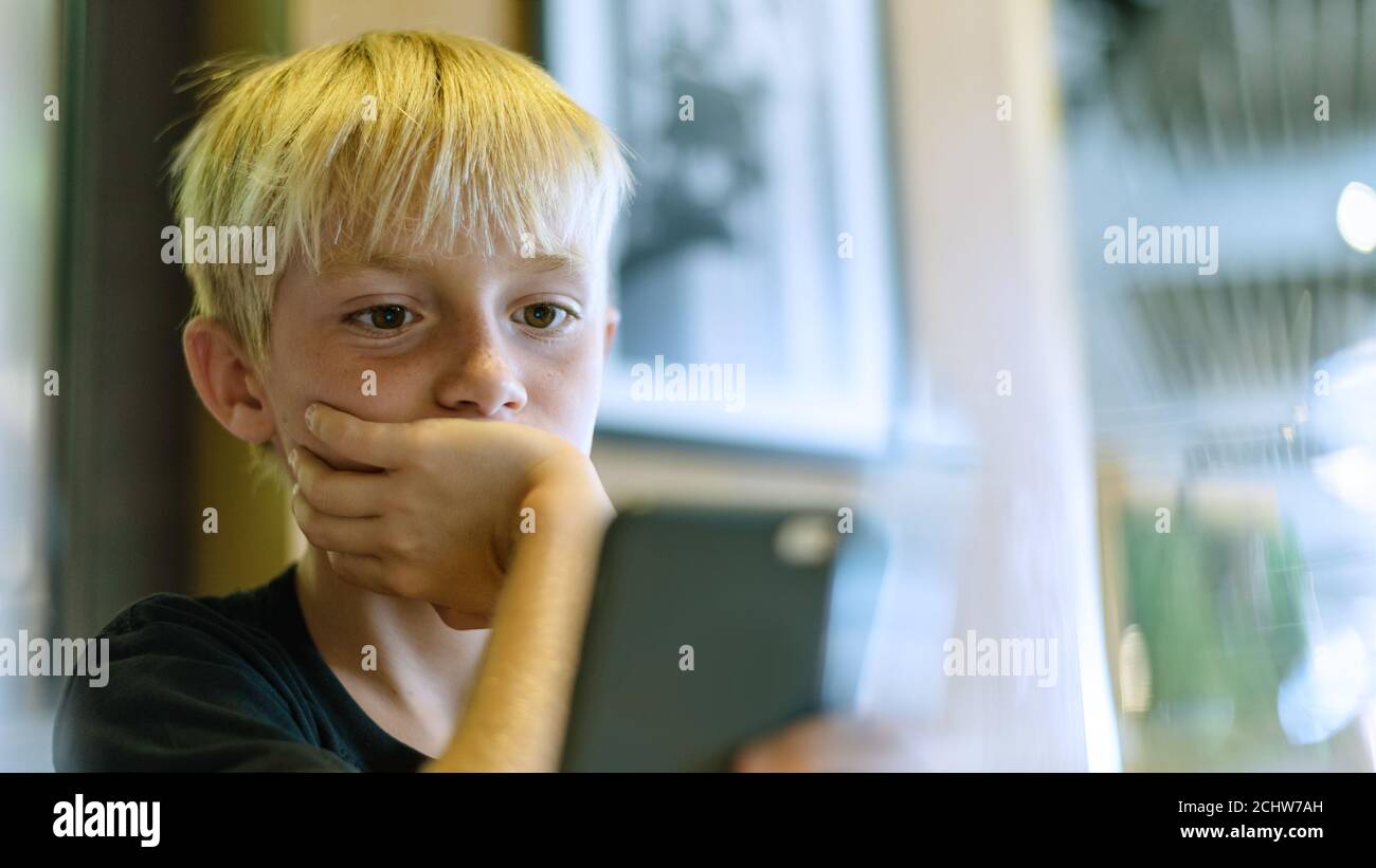 Bored kid with smartphone, child addicted to smartphone concept Stock ...