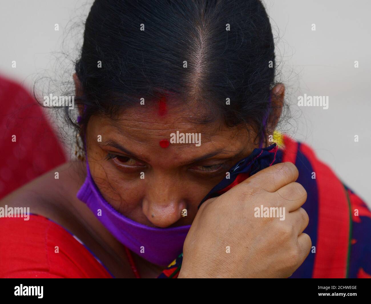 A family member of a coronavirus patient is crying in front of the ...