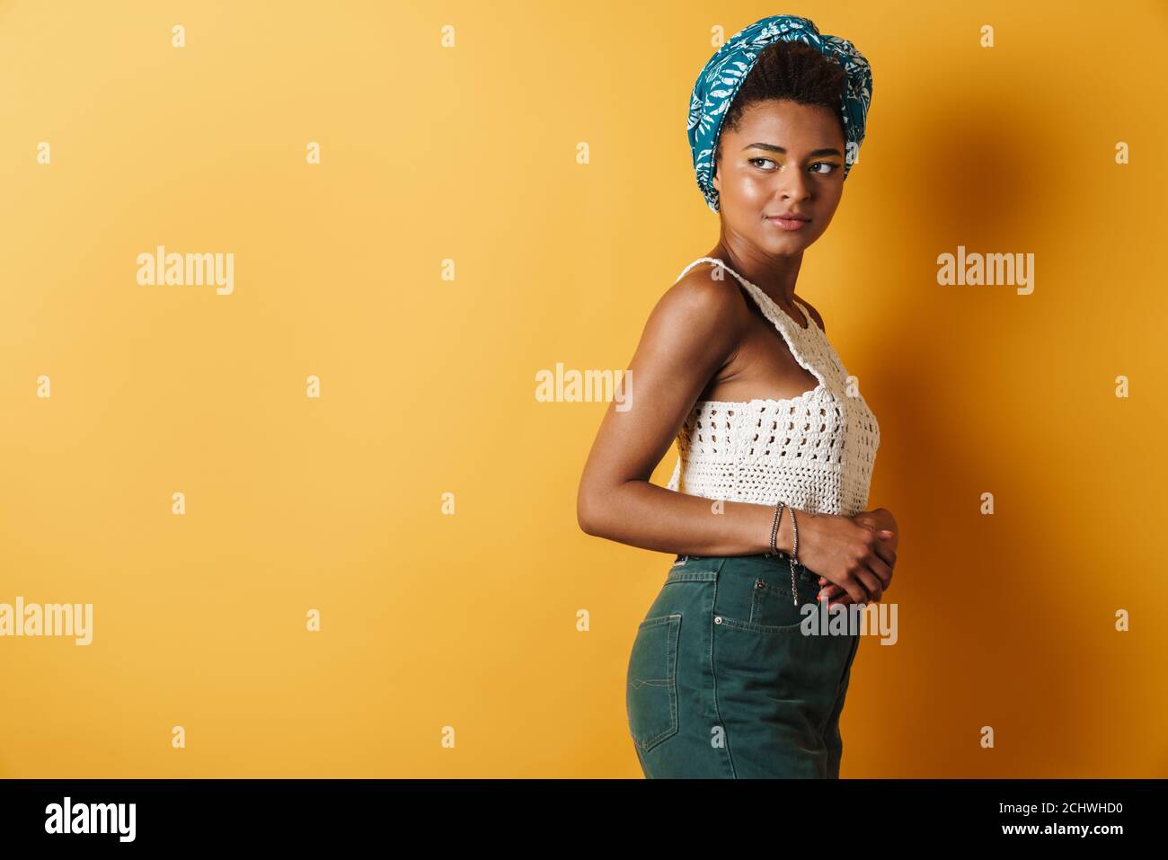 Image of pleased african american woman posing and looking aside ...