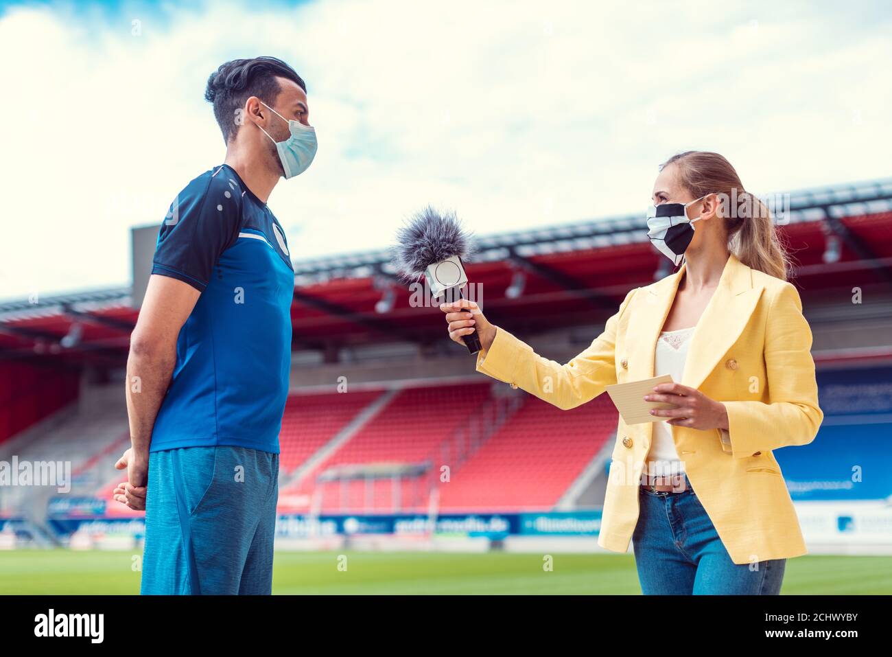 Reporter doing interview with football player during covid-19 Stock ...