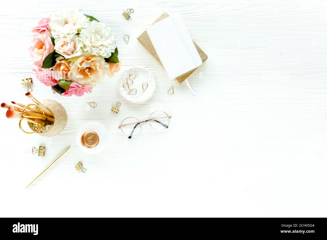 Flat lay women's office desk Female workspace with pink roses flowers ...