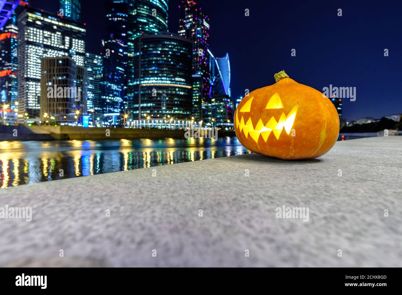 Halloween pumpkin on the background of Moscow city skyscrapers at night ...