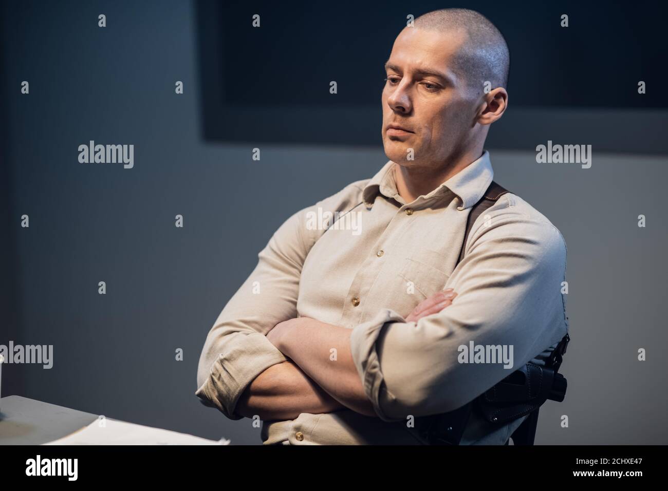 Portrait of a young handsome investigator in the interrogation room ...
